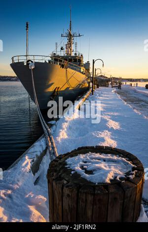 Minesweeper HMCS Kingston alongside a snow-covered wharf at Christmas ...