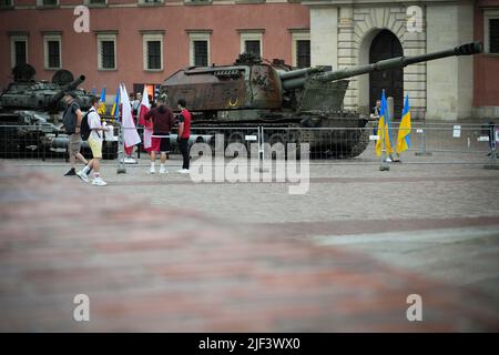 Visitors look at Russian tanks on display near the Royal Castle in ...