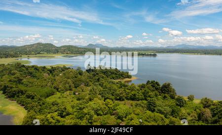 Aerial view of Sorabora lake in a mountain valley among the hills. Sri ...