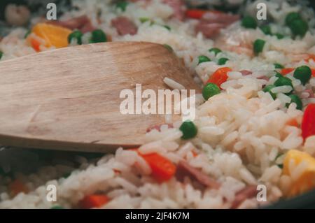 Rice three delights with the wooden cooking spade Stock Photo - Alamy