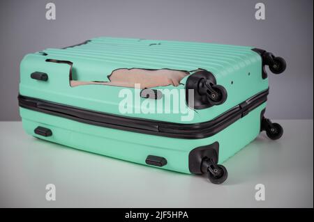 Mint damaged suitcase on a white background Stock Photo - Alamy