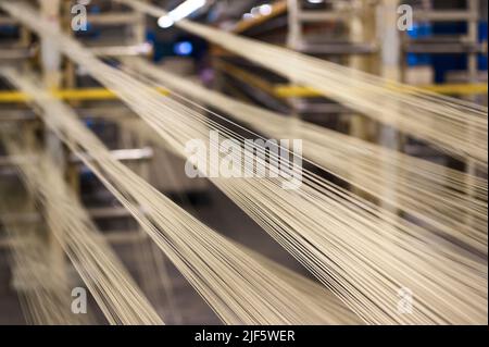 Cables for tires reinforcement in rolled steel workshop Stock Photo - Alamy