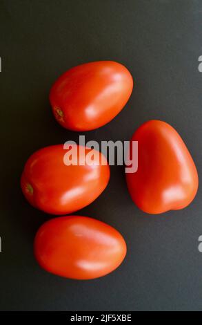 Ripe Roma tomatoes against a simple background Stock Photo - Alamy