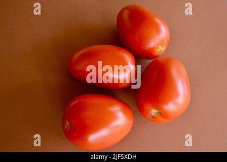Ripe Roma tomatoes against a simple background Stock Photo - Alamy