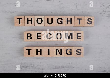 wooden cubes showing the words thoughts become things Stock Photo - Alamy