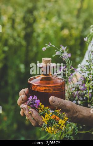 Old woman makes herbal tincture. Selective focus Stock Photo - Alamy