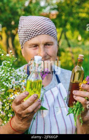 Old woman makes herbal tincture. Selective focus Stock Photo - Alamy