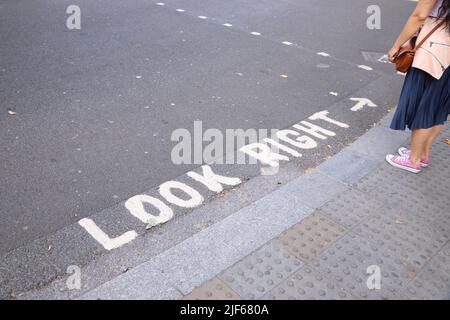 London UK pedestrian sign - look right at a pedestrian crossing ...
