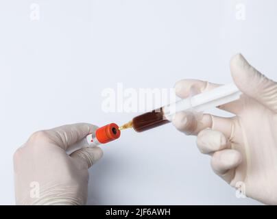 Handling blood probes with syringe and test tube for analyzing to in a ...