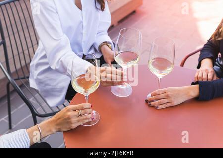 Cropped unrecognizable ethnic adult brunettes in smart casual clothes ...