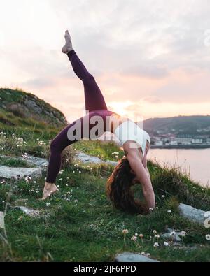 Young woman athlete in sportswear doing exercises with dumbbells in ...