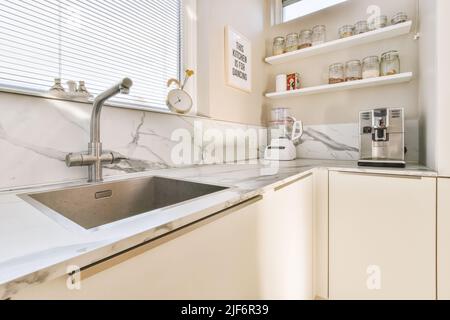 Fragment of interior of light narrow home kitchen with minimalist style ...