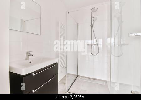 Sinks with mirrors and shower box with glass door in modern bathroom ...