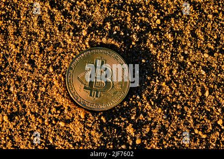 Bitcoin coin in sand at sunset, collapse and fall cryptocurrency Stock ...