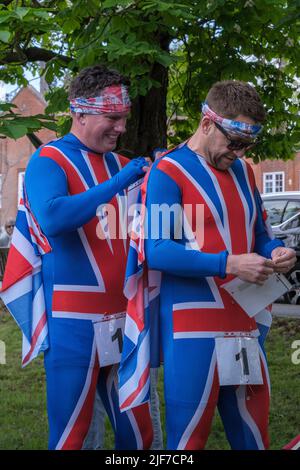 Two men of Pinner Players Theatre Company push a wheel barrow down ...