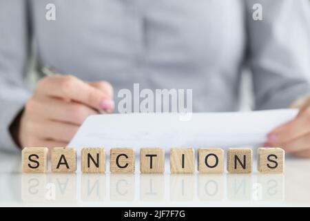 Text sanctions list on white note paper Stock Photo - Alamy