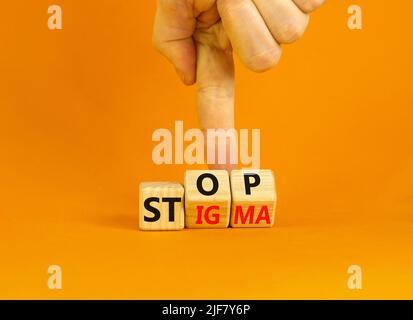 Stop and Stigma symbol. Businessman hand points at wooden cubes with ...