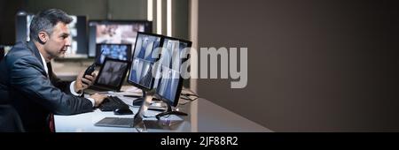 Businessman Looking At CCTV Camera Footage On Digital Tablet Stock ...