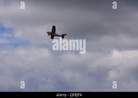 Plane flying within dark clouds with smoke on tail Stock Photo - Alamy