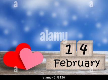 Vintage alarm clock and text 14 february on wood block with pink bokeh ...