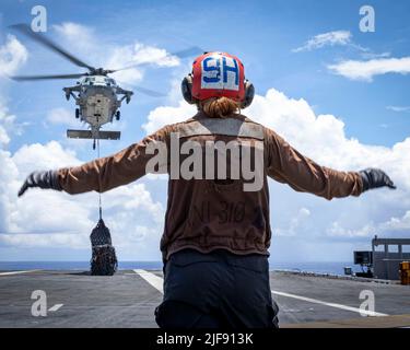 US Navy A Sailor assigned to Weapons Department gets ready to shoot a M ...