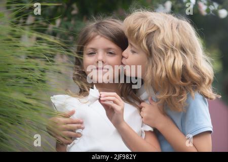 Hugging and kissing kids couple. Little lovely children outdoor ...