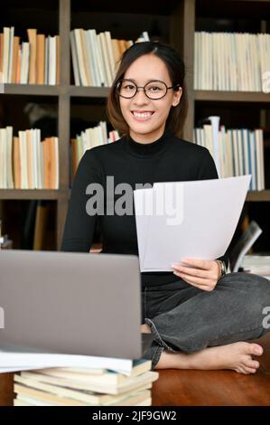 Young writer working in the library Stock Photo - Alamy