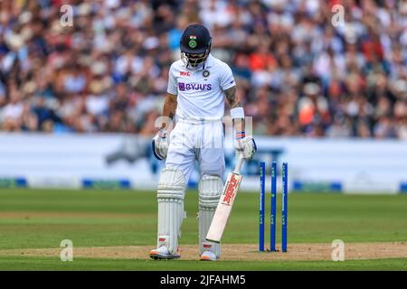 A dejected Virat Kohli of India leaves the field after being bowled out ...