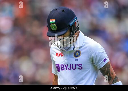 A dejected Virat Kohli of India leaves the field after being bowled out ...