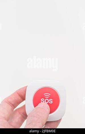 person holding device with red SOS button - help request and danger ...