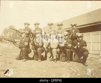 Men in landstorm uniform set up with rifles in front of the fence in ...