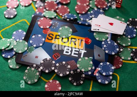 Smartphone with poket table on screen, playing cards and chip cards on ...