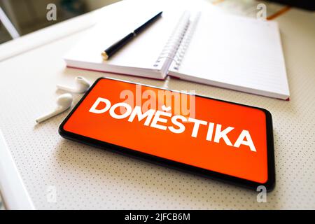 In this photo illustration the Domestika logo seen displayed on a ...
