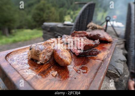 Typical Uruguayan and Argentine Asado Cooked on fire. Entrana and Vacio ...