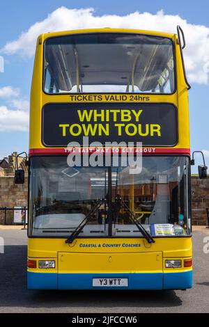 Whitby Town Tour Bus travelling through the centre of Whitby, England ...