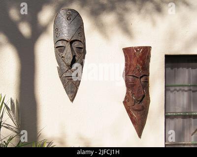 African masks hanging on a wall Stock Photo - Alamy
