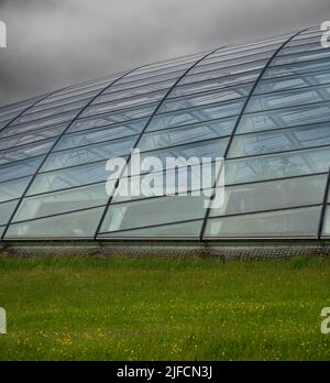Futuristic conservatory dome of glass panels in steel joists, set into ...