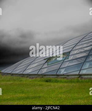 Futuristic conservatory dome of glass panels in steel joists, set into ...