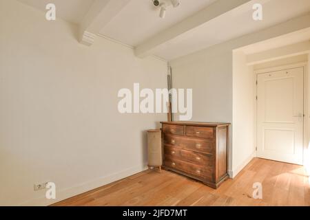 Plastic window and radiator on white wall in empty light room at home ...