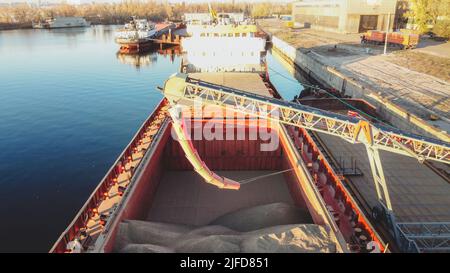 Bulk carrier at port grain elevator. Panamax bulk carrier loaded with ...