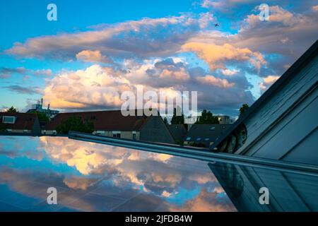 Colorful sunset cloudscape reflected in calm water of Pine Glades Lake ...
