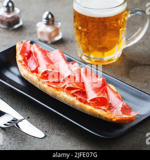 Traditional Spanish breakfast. Tostada with different toppings on a ...