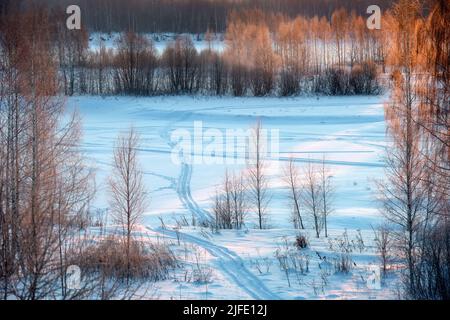 Traces of vehicles and people on the frozen and snow-covered Volga ...