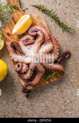 Octopus cooked with chopped herbs served on a board Stock Photo - Alamy
