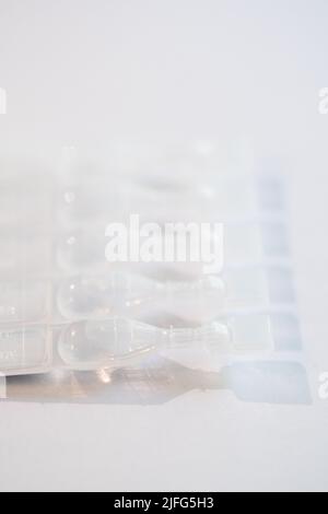 Photo of containers for eye drops on white background Stock Photo - Alamy