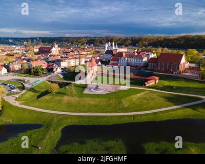 A Kaunas castle made of red brick with a large bridge over a river on ...