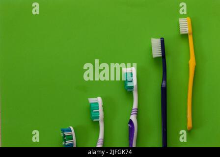 Toothbrushes of different colors close up on a white vintage background ...