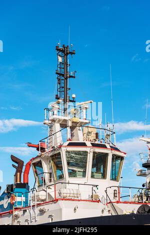 Modern tugboat moored in the sea port Stock Photo - Alamy