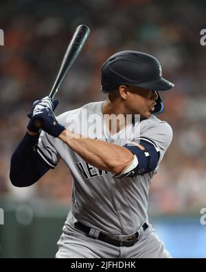 New York Yankees' Giancarlo Stanton watches the ball he hit go into the ...