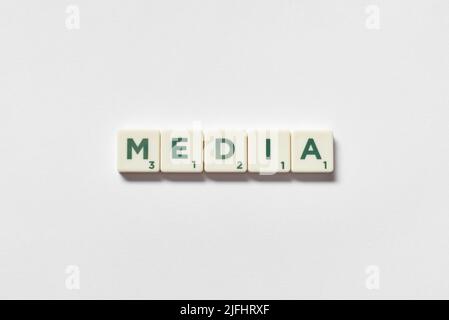 Media formed of scrabble blocks on yellow background Stock Photo - Alamy